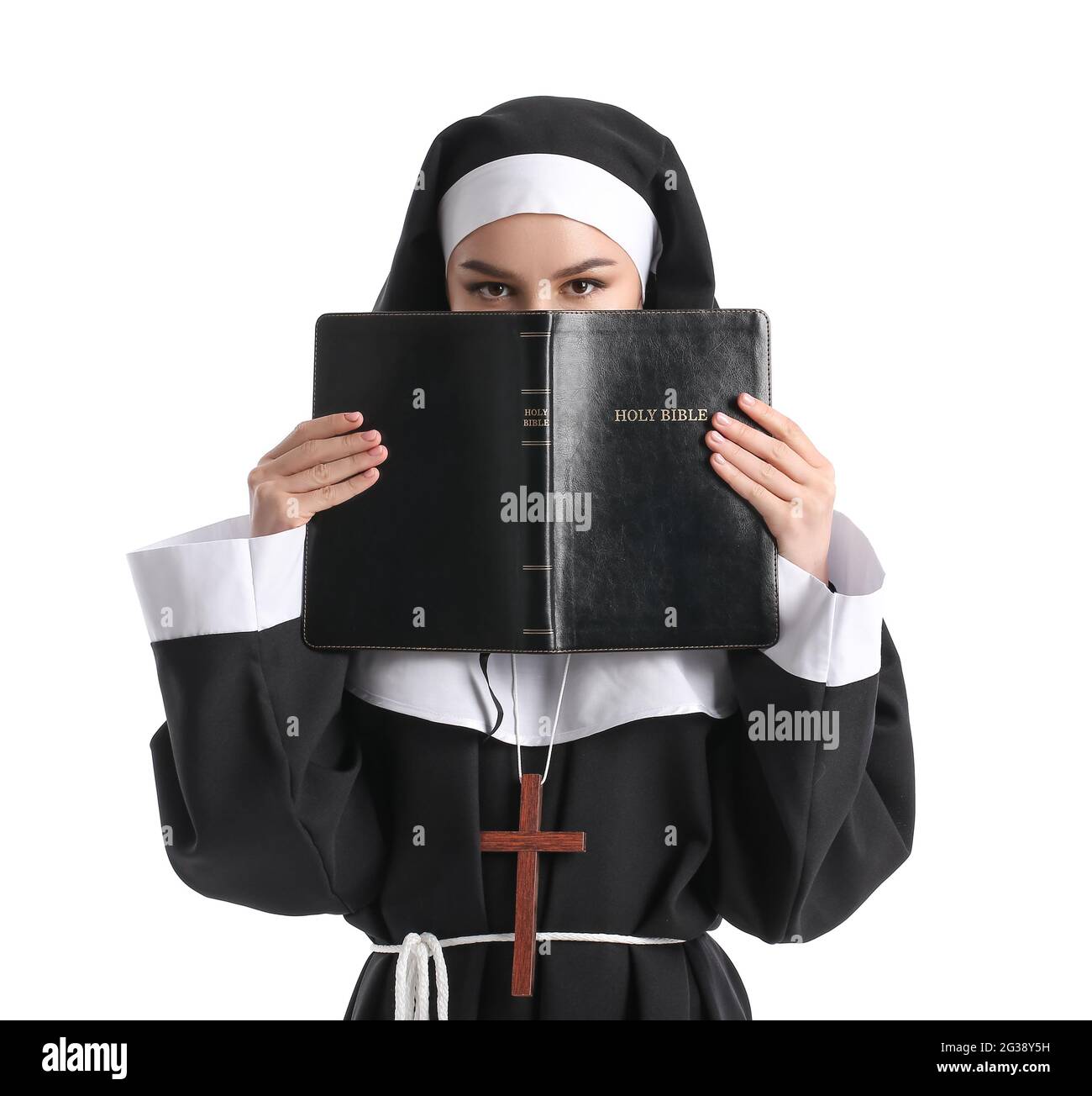 Young nun with Bible on white background Stock Photo - Alamy