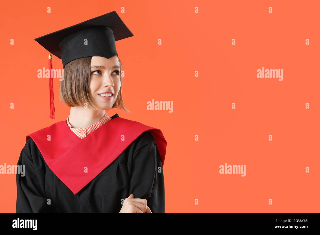 Female graduating student on color background Stock Photo - Alamy