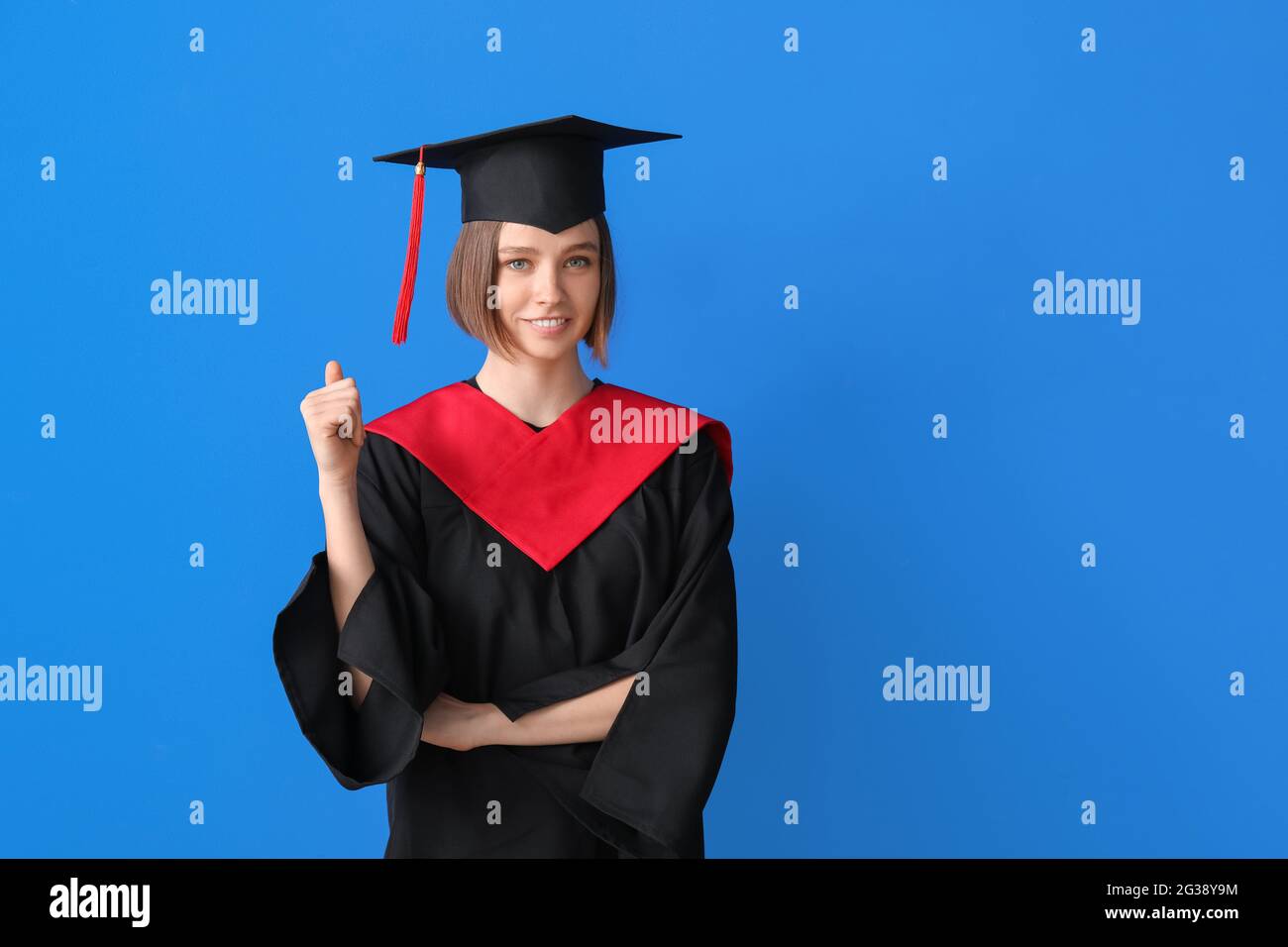 Happy female graduating student on color background Stock Photo - Alamy