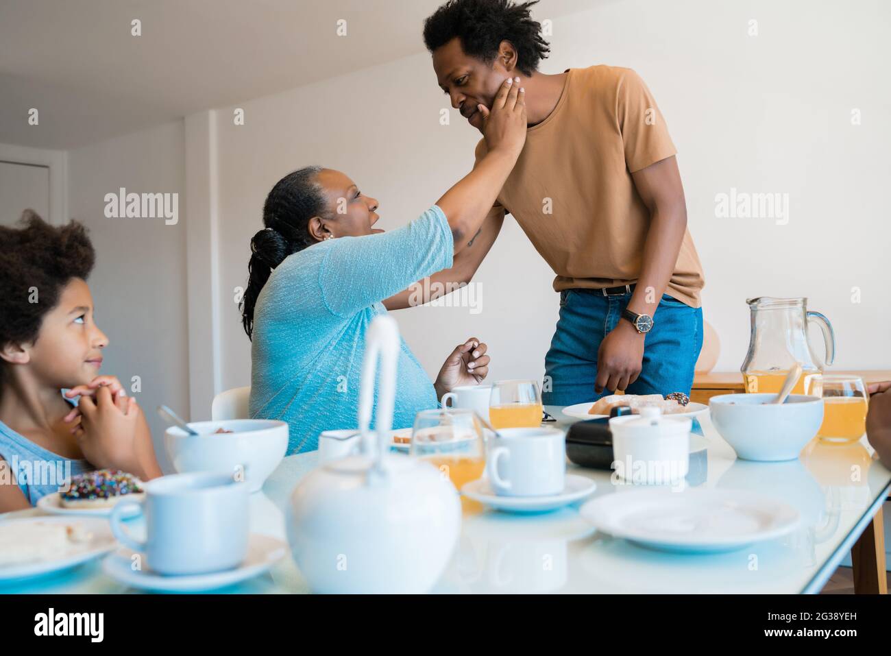 Family having breakfast together at home Stock Photo - Alamy