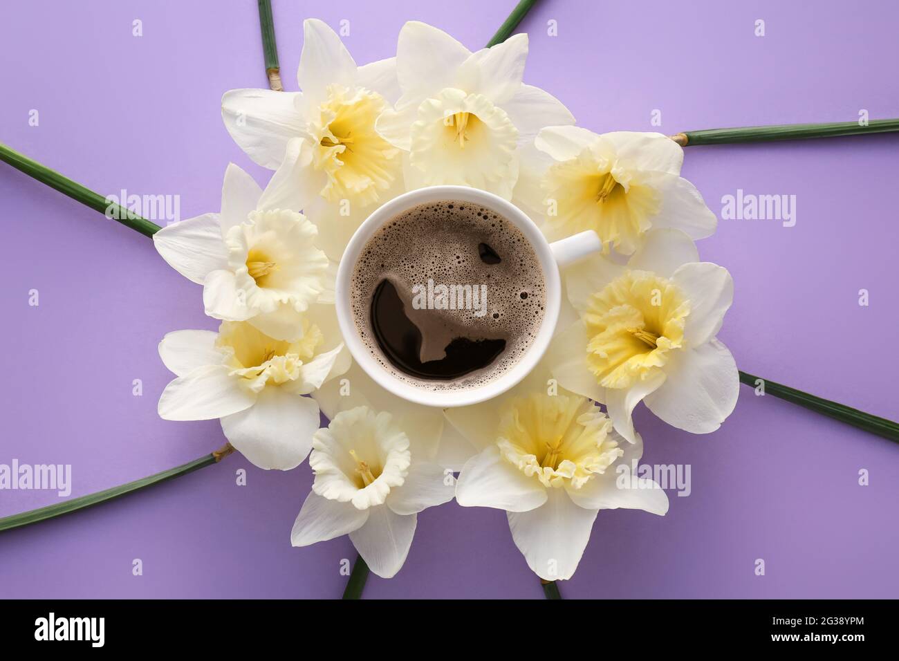 Cup of coffee and beautiful daffodils on color background Stock Photo ...