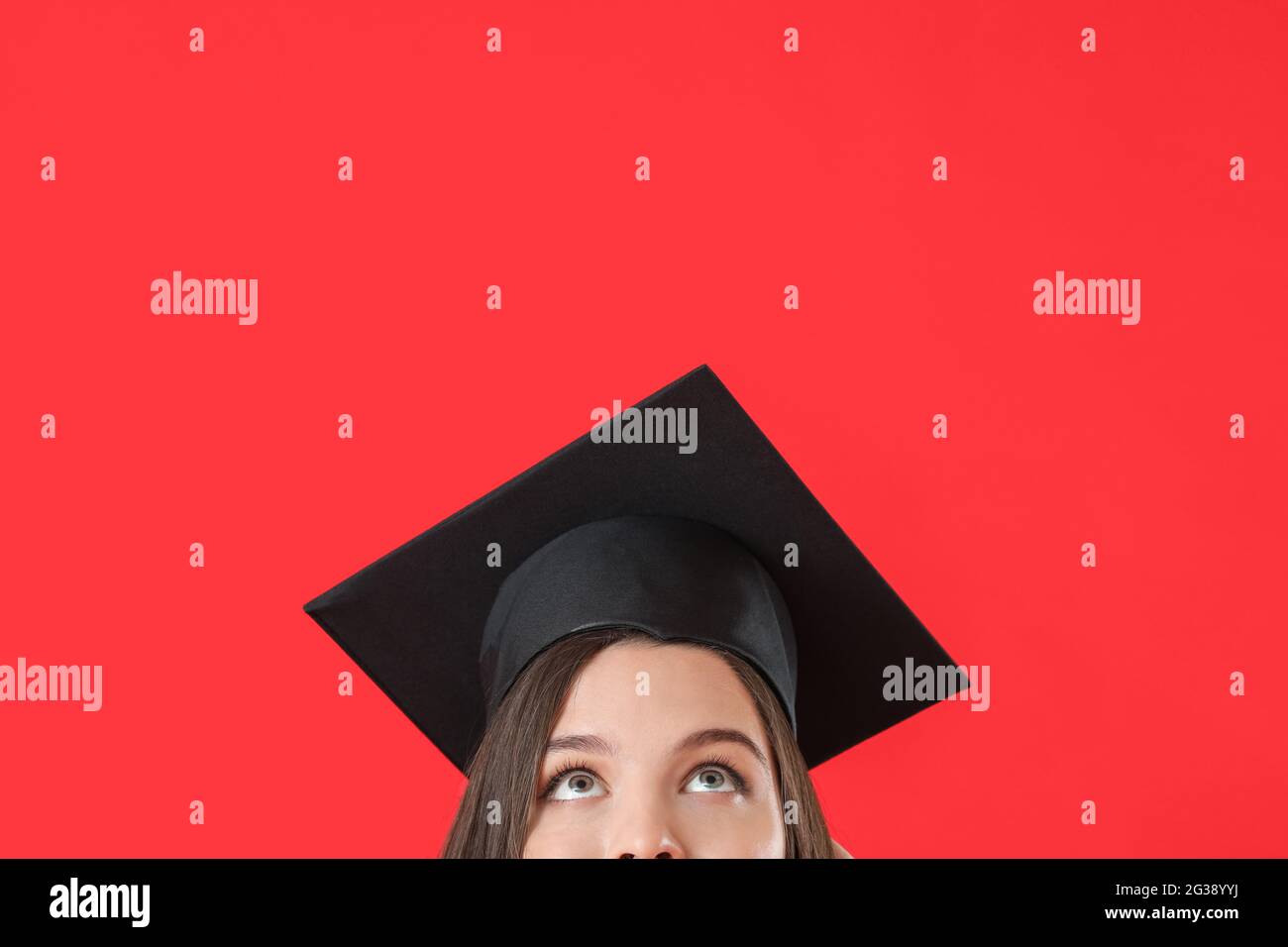 Female graduating student on color background Stock Photo - Alamy