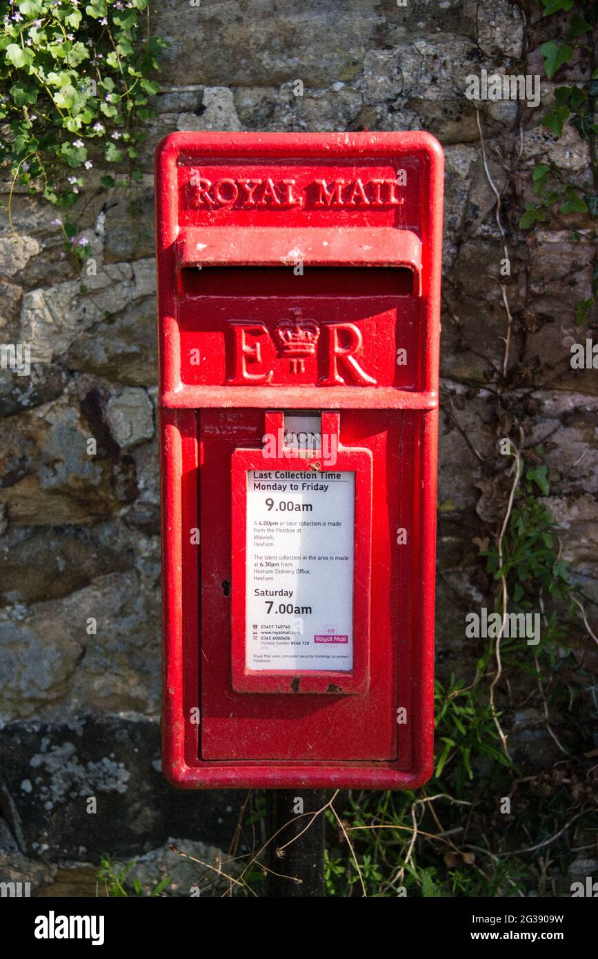 Ever present Royal Mail: a classic red letterbox on a wall in ...