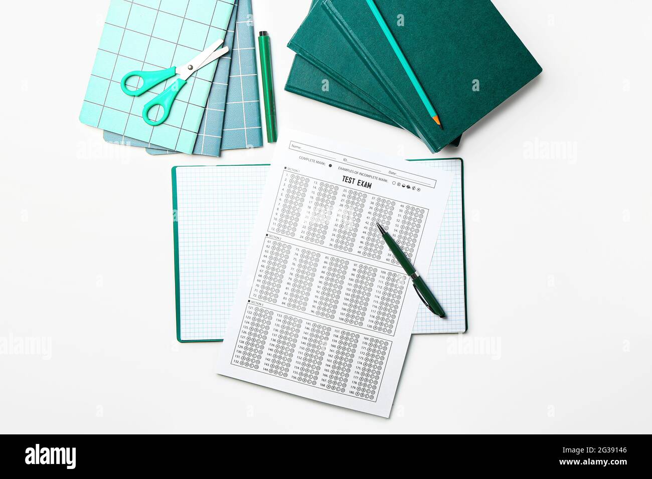 Answer sheet, stationery and notebooks on white background Stock Photo ...