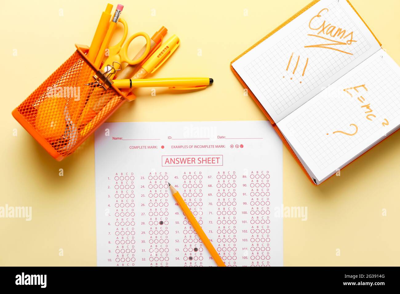 Answer sheet, stationery and notebook with text EXAMS on color ...