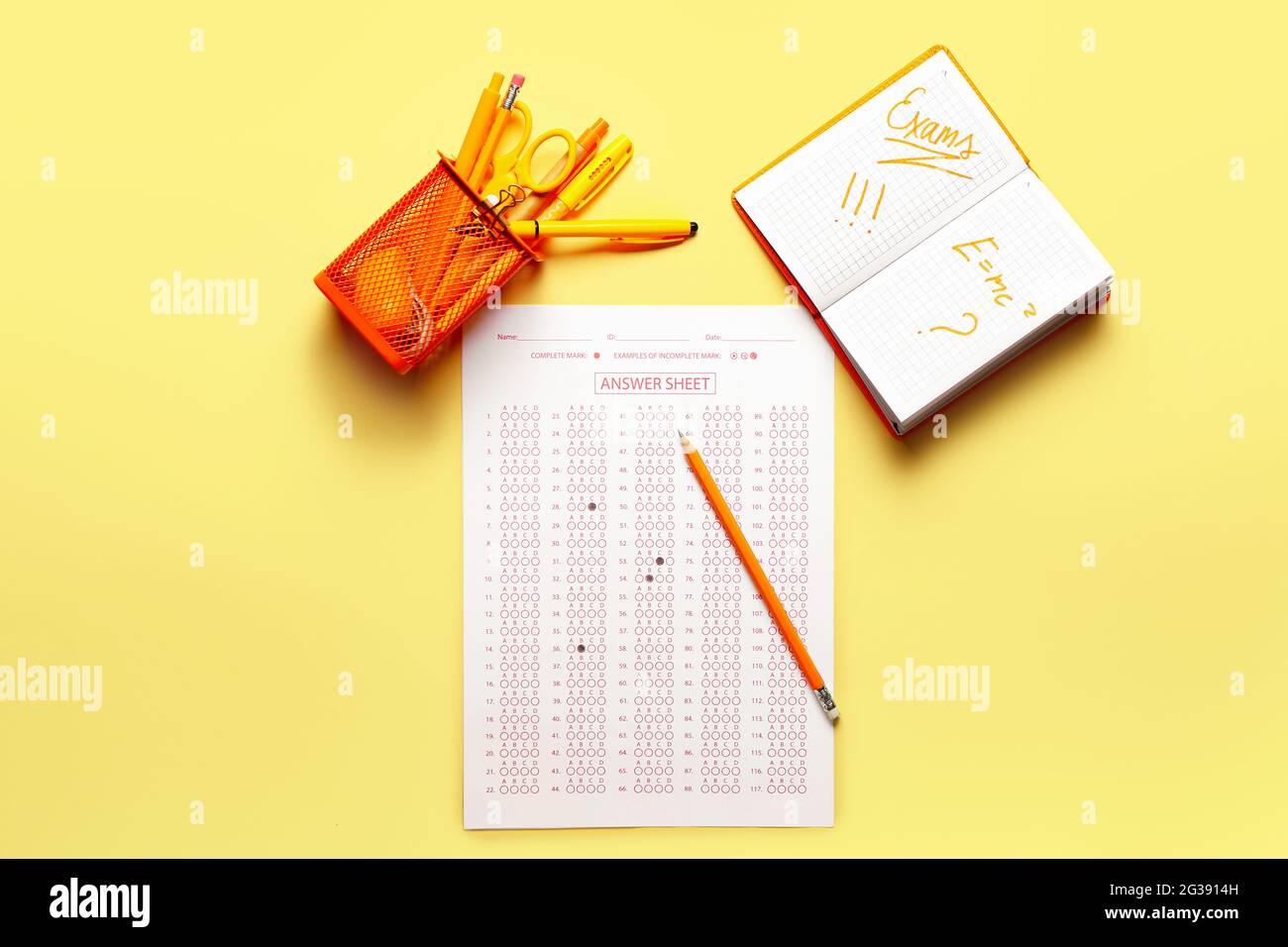 Answer sheet, stationery and notebook with text EXAMS on color ...