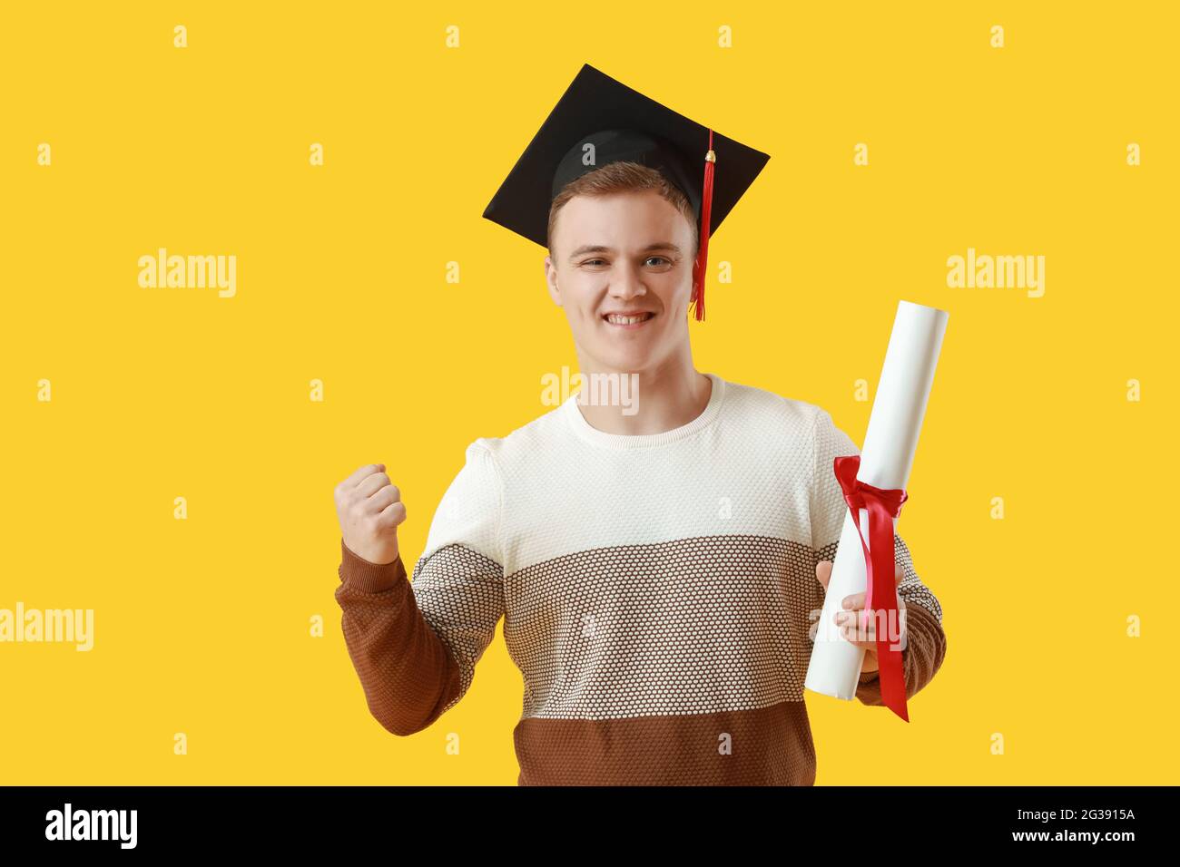 Happy graduating student on color background Stock Photo - Alamy