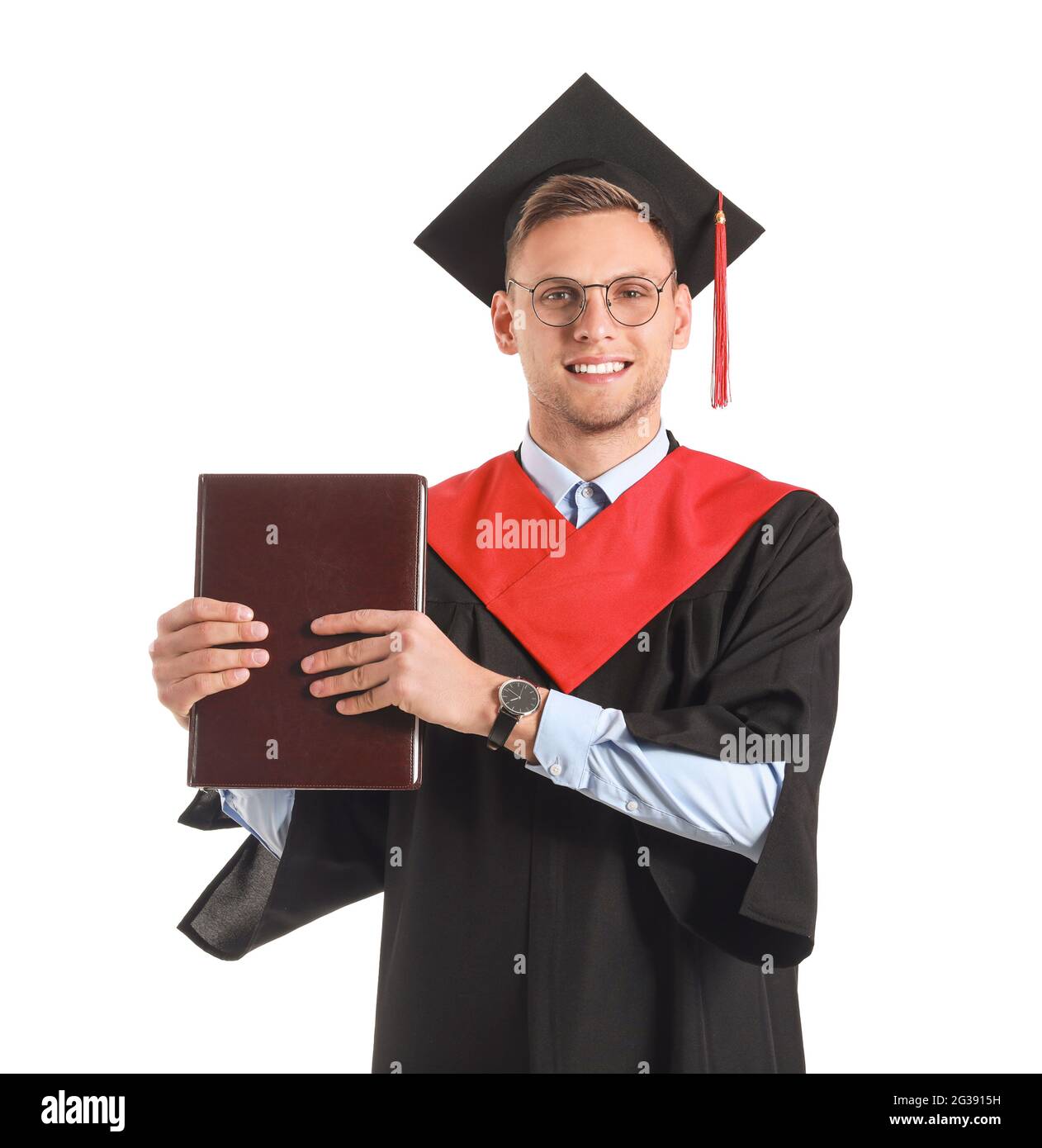 Male graduating student with book on white background Stock Photo - Alamy