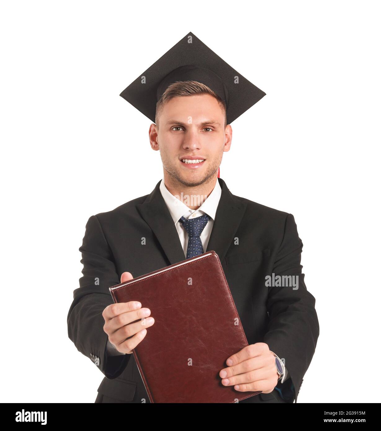 Male graduating student with book on white background Stock Photo - Alamy