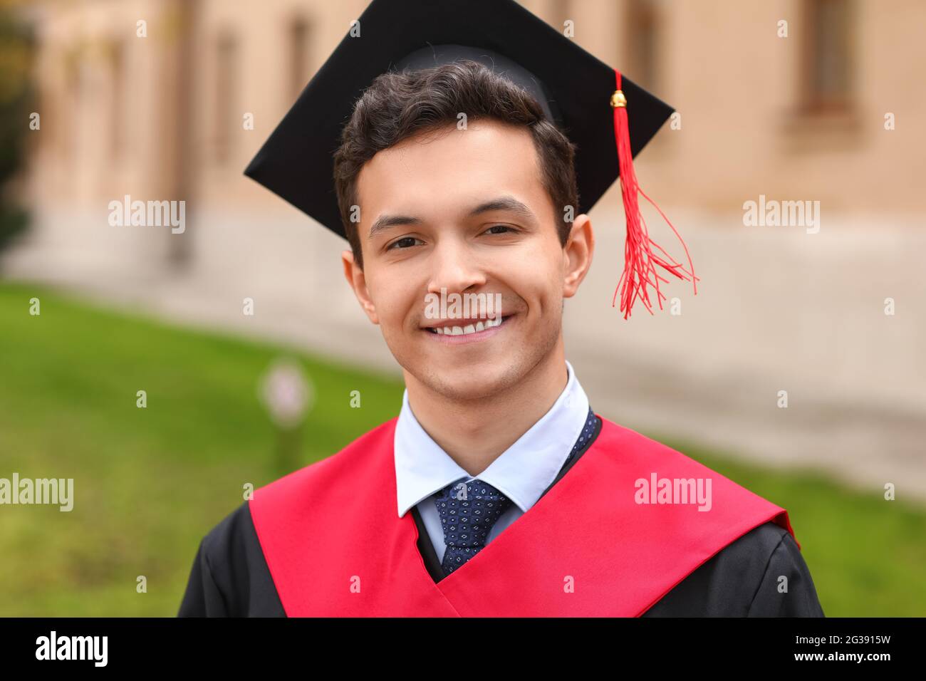 Portrait of male graduating student outdoors Stock Photo - Alamy