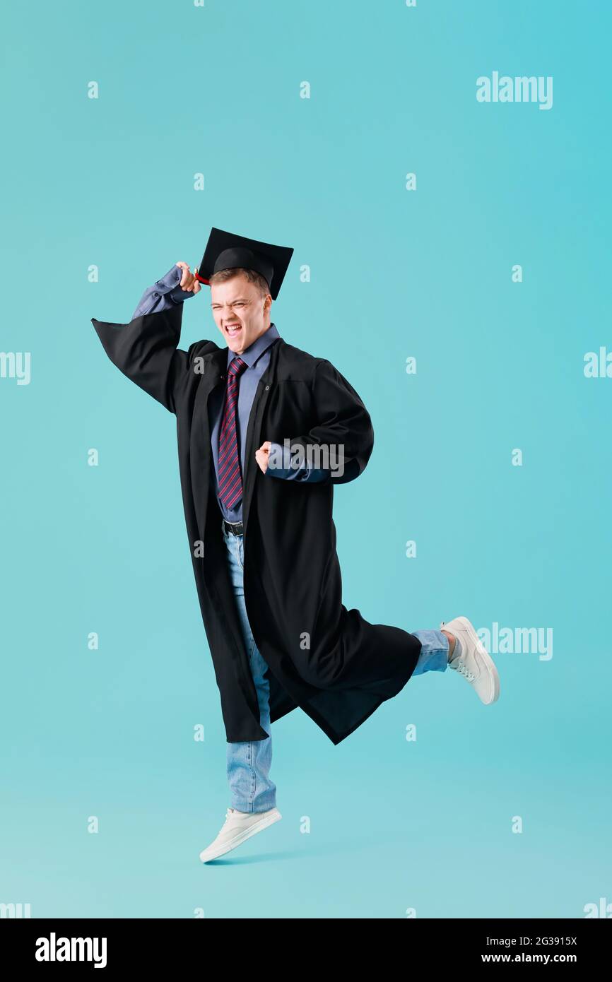 Jumping graduating student on color background Stock Photo - Alamy