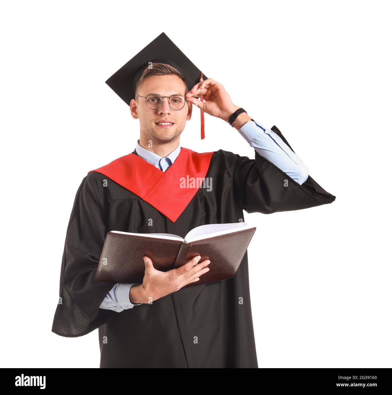 Male graduating student with book on white background Stock Photo - Alamy