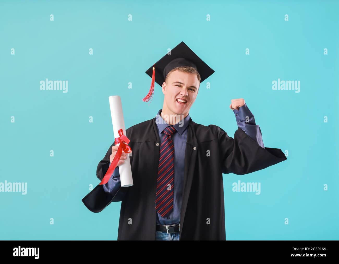Happy graduating student on color background Stock Photo - Alamy