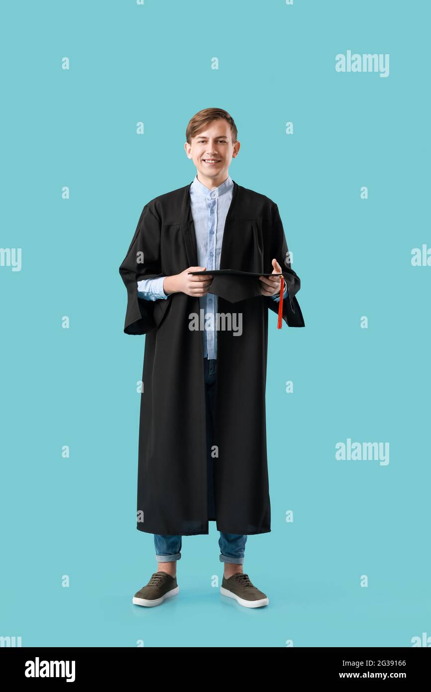 Male graduating student on color background Stock Photo - Alamy