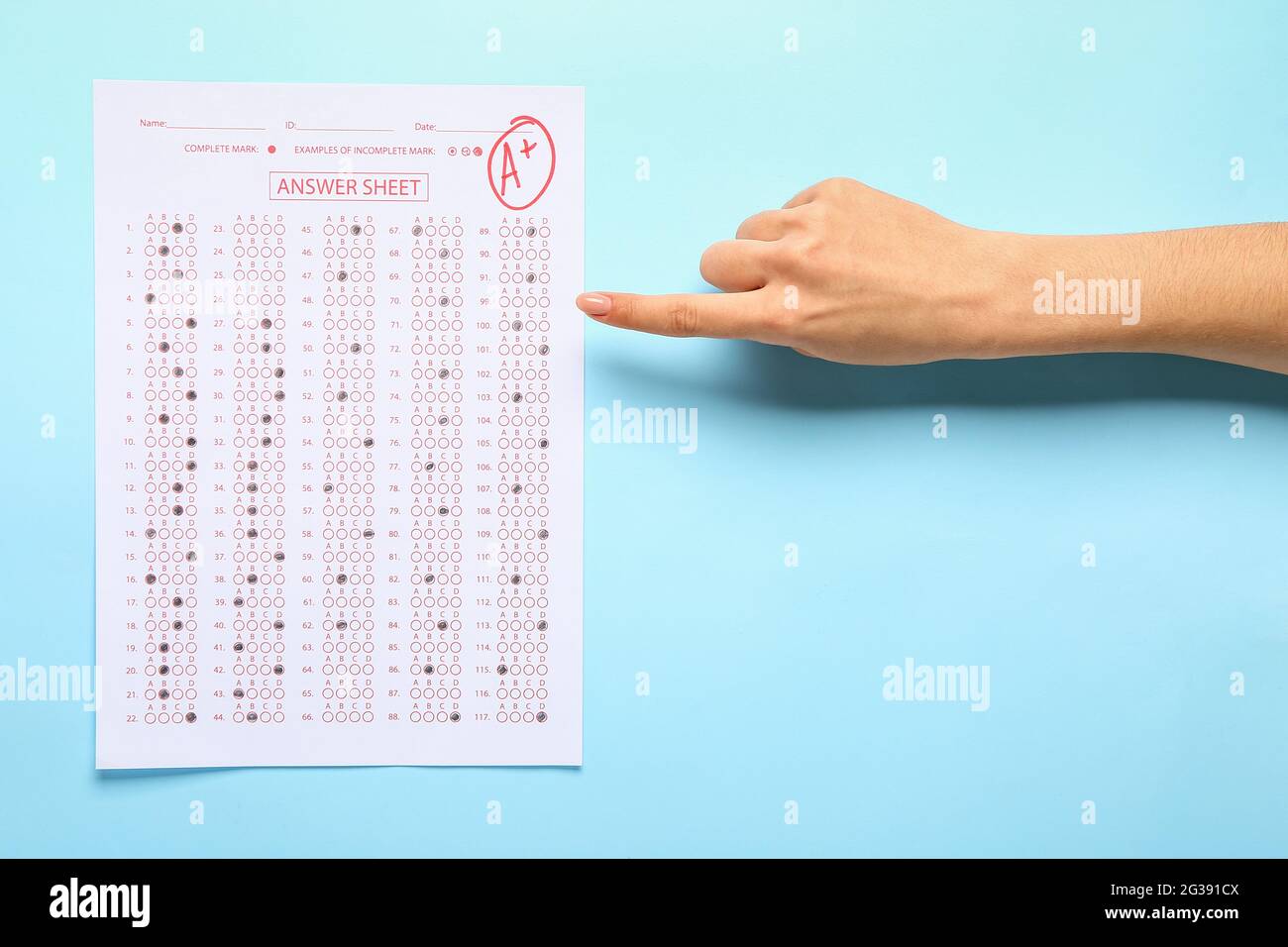 Female hand with answer sheet form on color background Stock Photo - Alamy