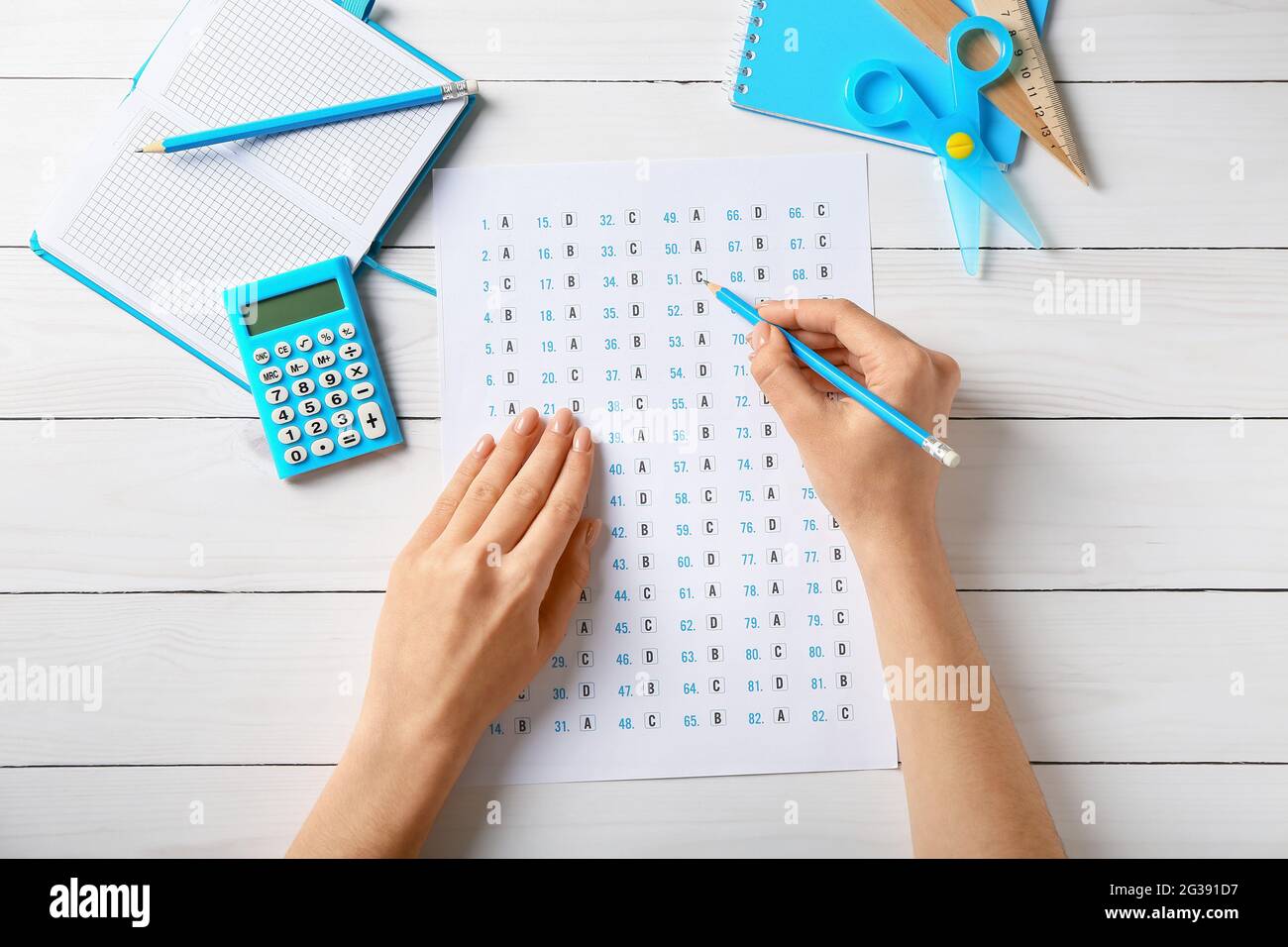 Student passing school test at table Stock Photo - Alamy