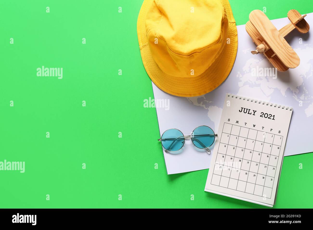 Calendar, world map and travel accessories on color background Stock ...