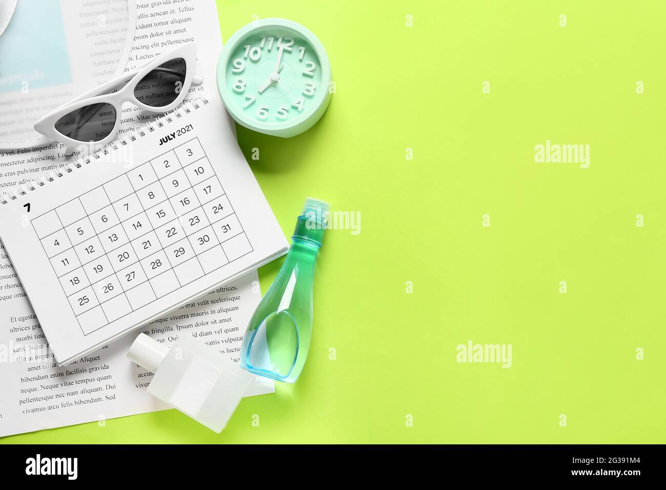 Calendar, newspaper, alarm clock and accessories on color background ...