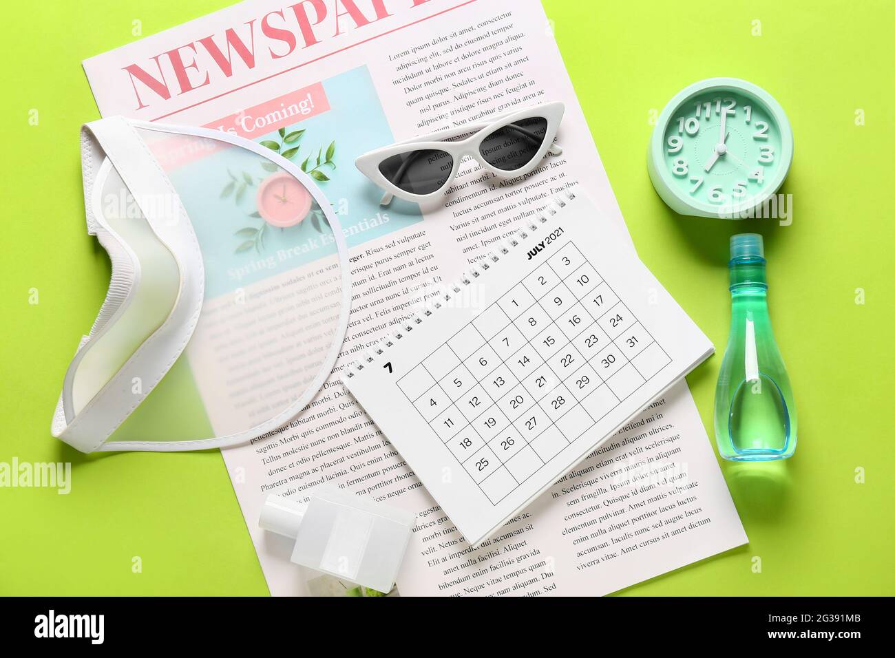 Calendar, newspaper, alarm clock and accessories on color background ...