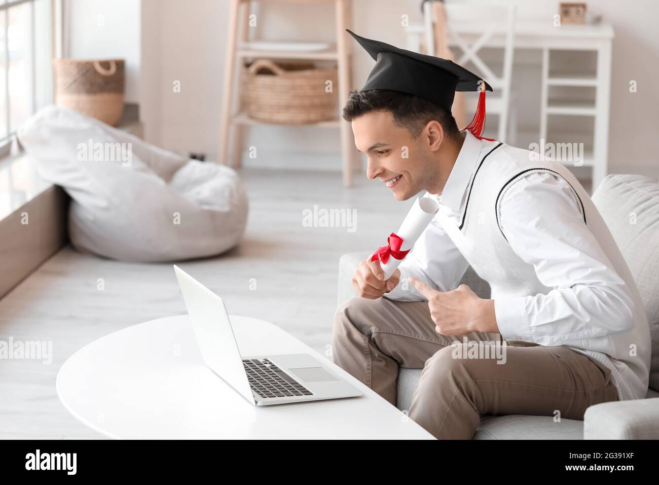 Happy male student on his graduation day at home. Concept of online ...