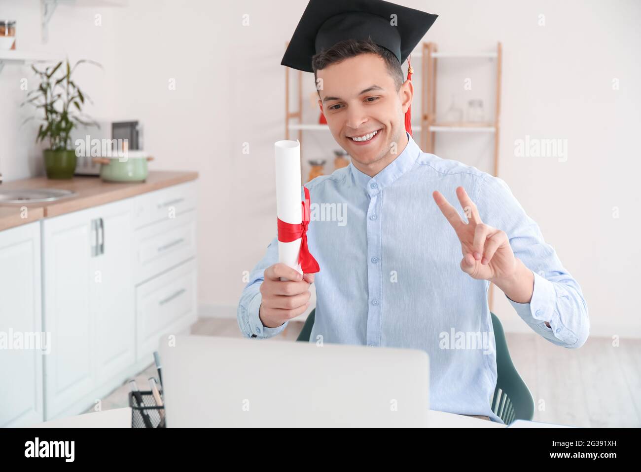 Happy male student on his graduation day at home. Concept of online ...