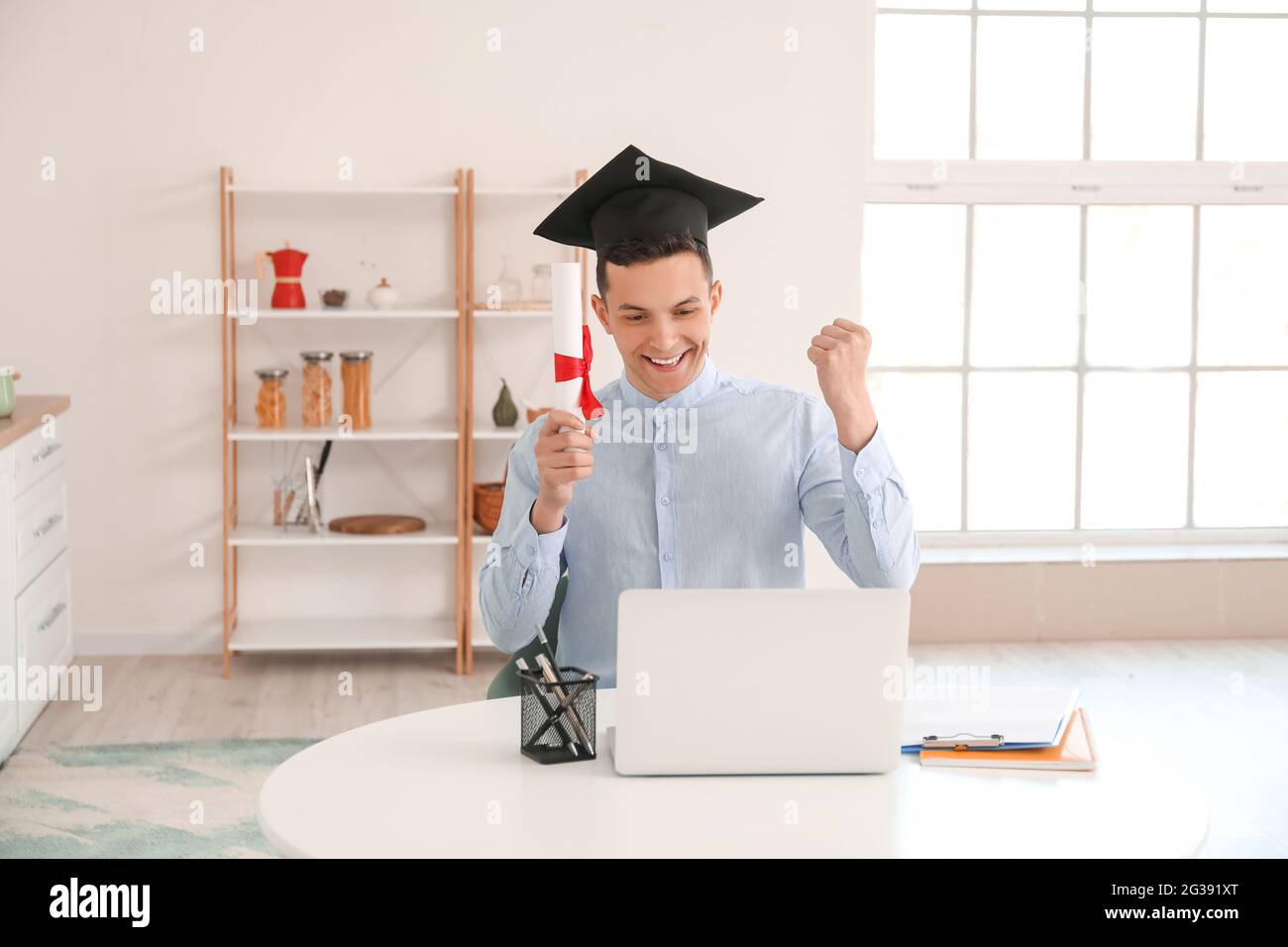 Happy male student on his graduation day at home. Concept of online ...