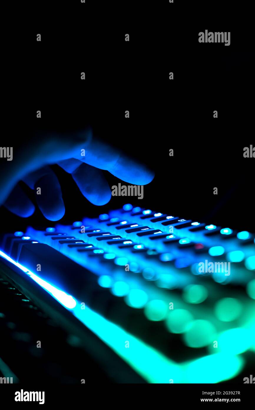 perspective side view detail closeup of male fingers typing on ...