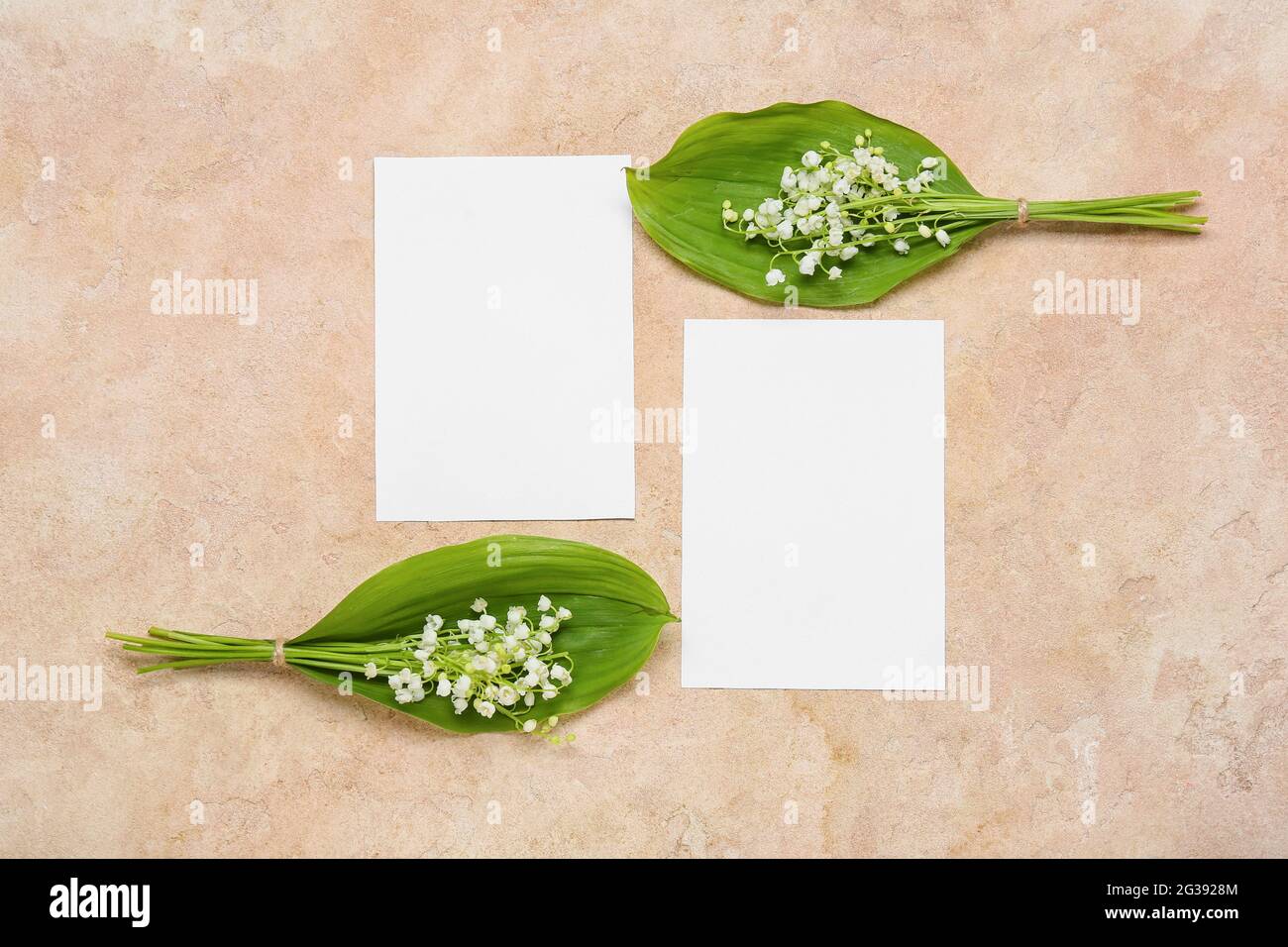 Beautiful lily-of-the-valley flowers and blank cards on color ...