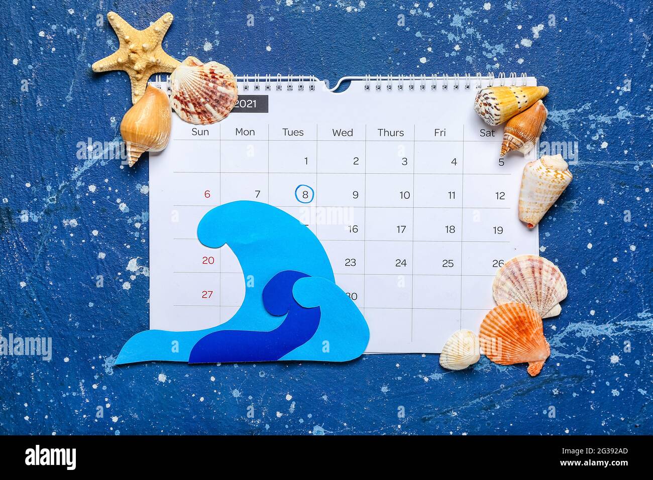 Calendar with marked date of World Ocean Day and sea shells on color ...