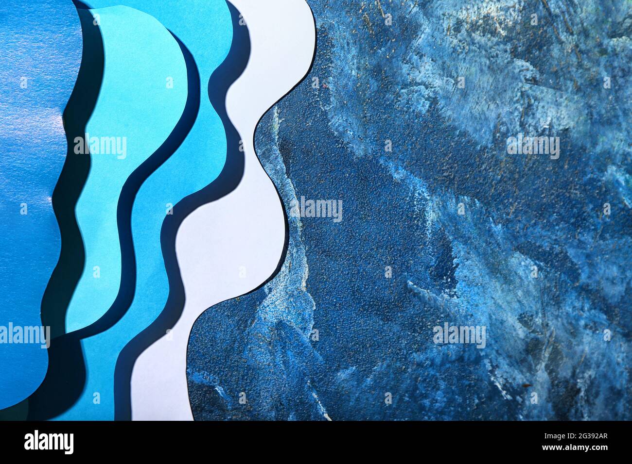 Paper sea waves on color background. Ecology concept Stock Photo - Alamy