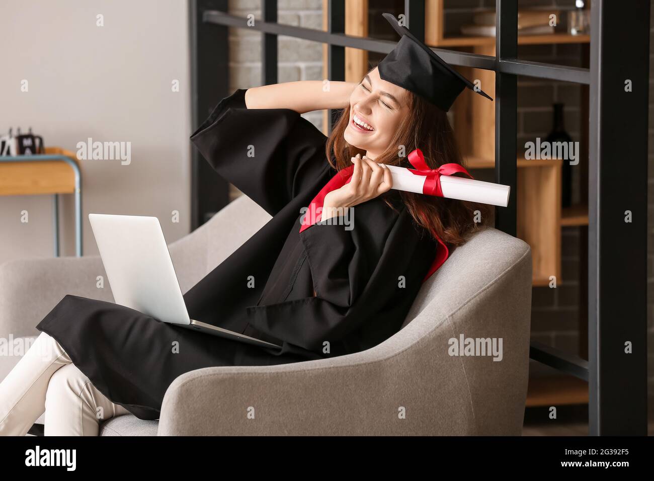 Happy female student on her graduation day at home. Concept of studying ...