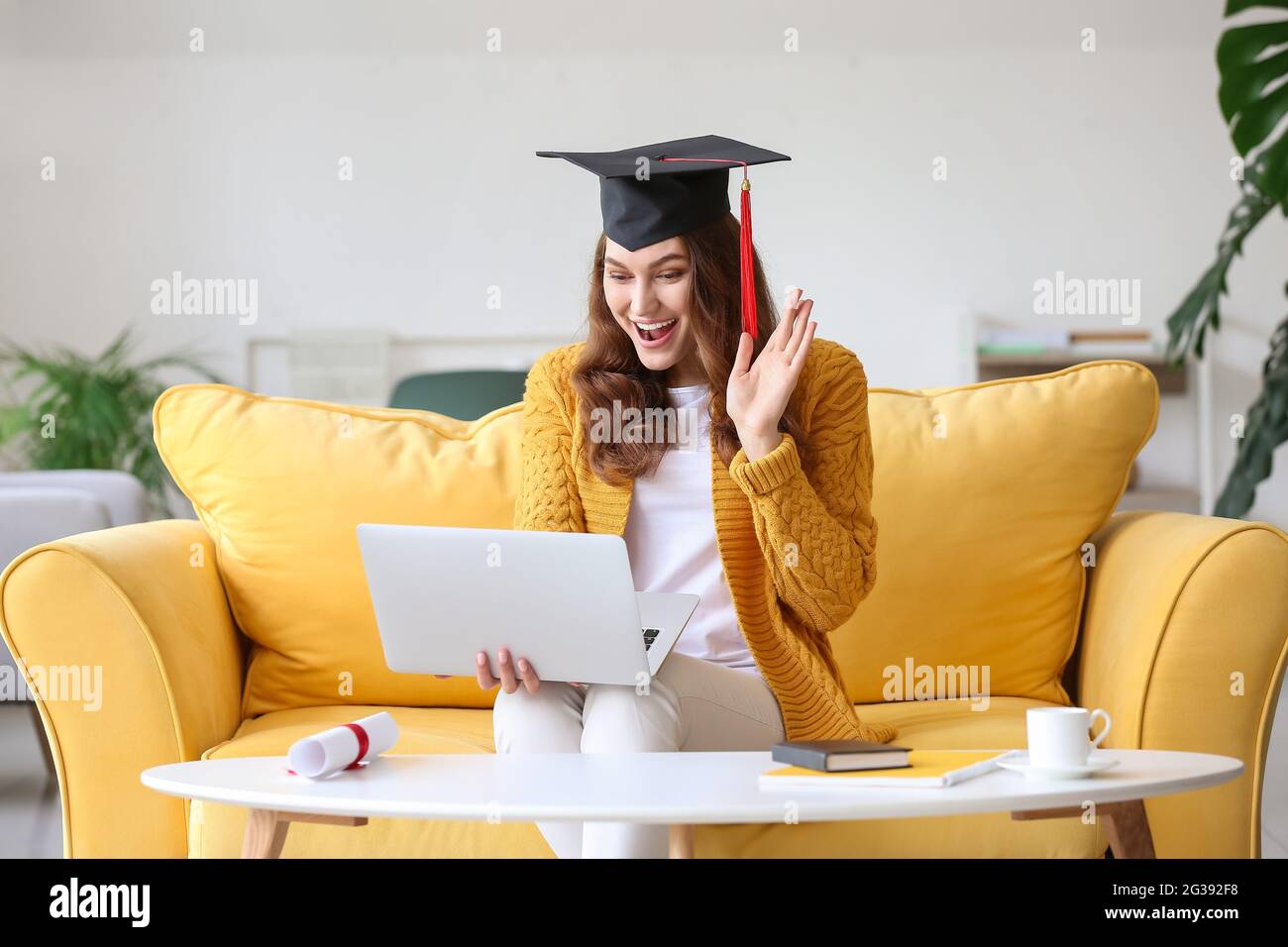 Happy female student on her graduation day at home. Concept of studying ...