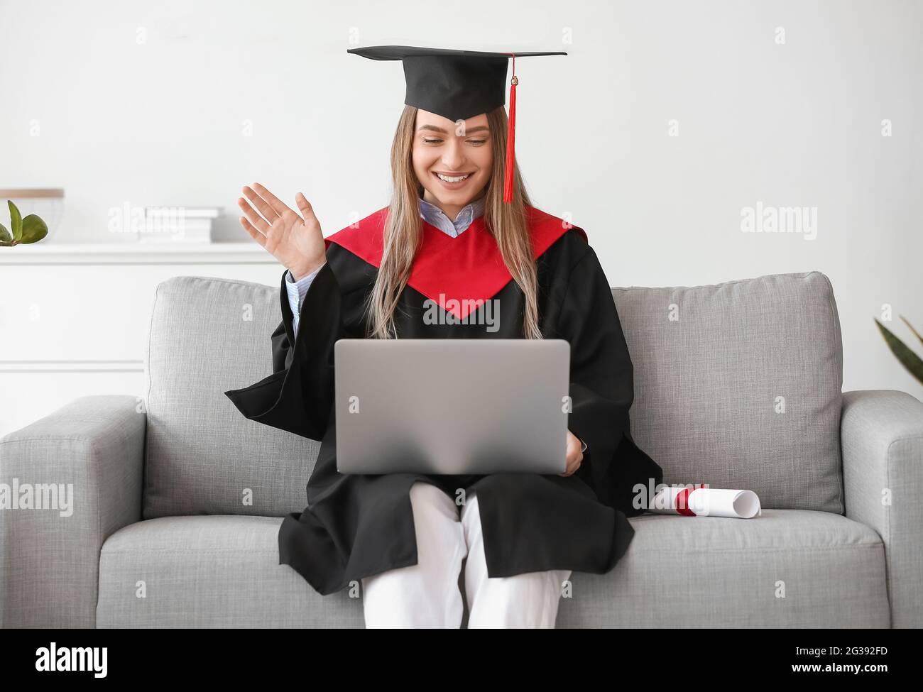 Happy female student on her graduation day at home. Concept of studying ...