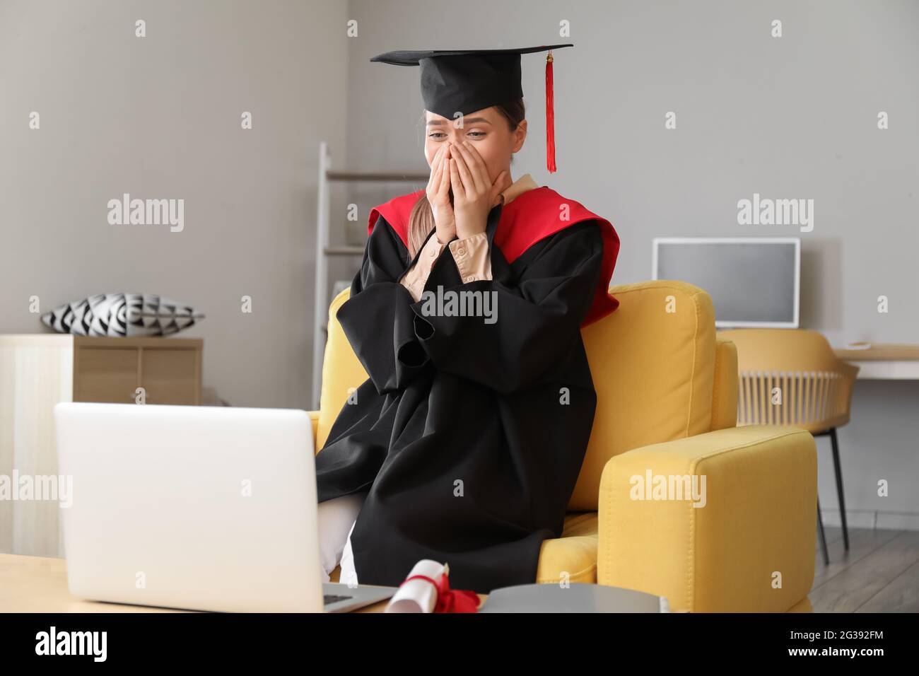 Happy female student on her graduation day at home. Concept of studying ...