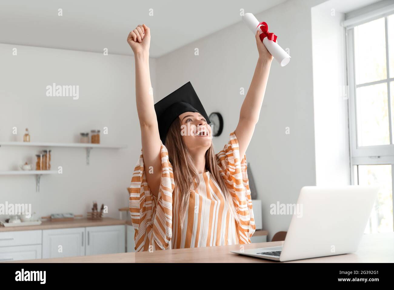 Happy female student on her graduation day at home. Concept of studying ...