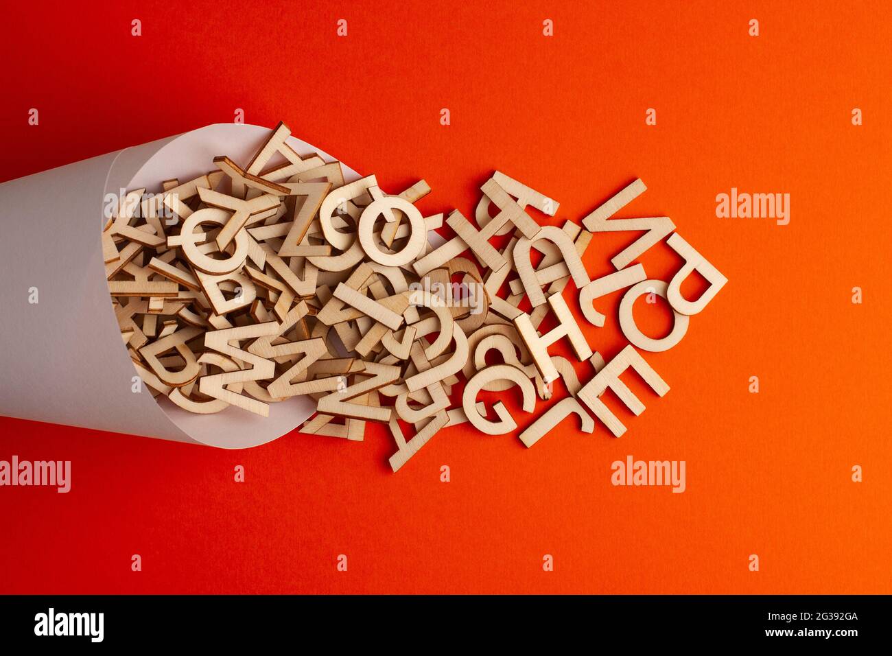 top view closeup of small wooden alphabet letters getting spilled from ...