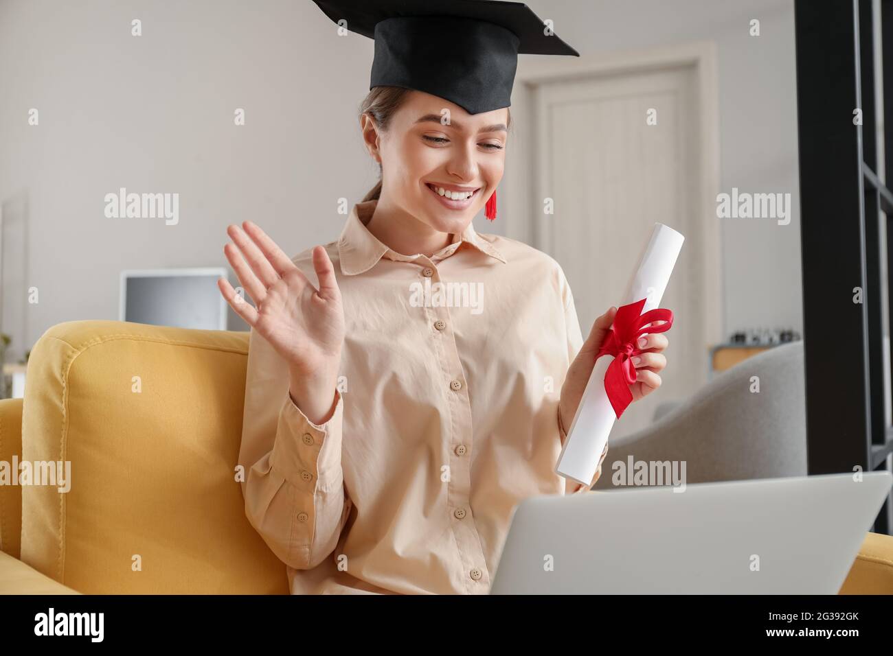 Happy female student on her graduation day at home. Concept of studying ...