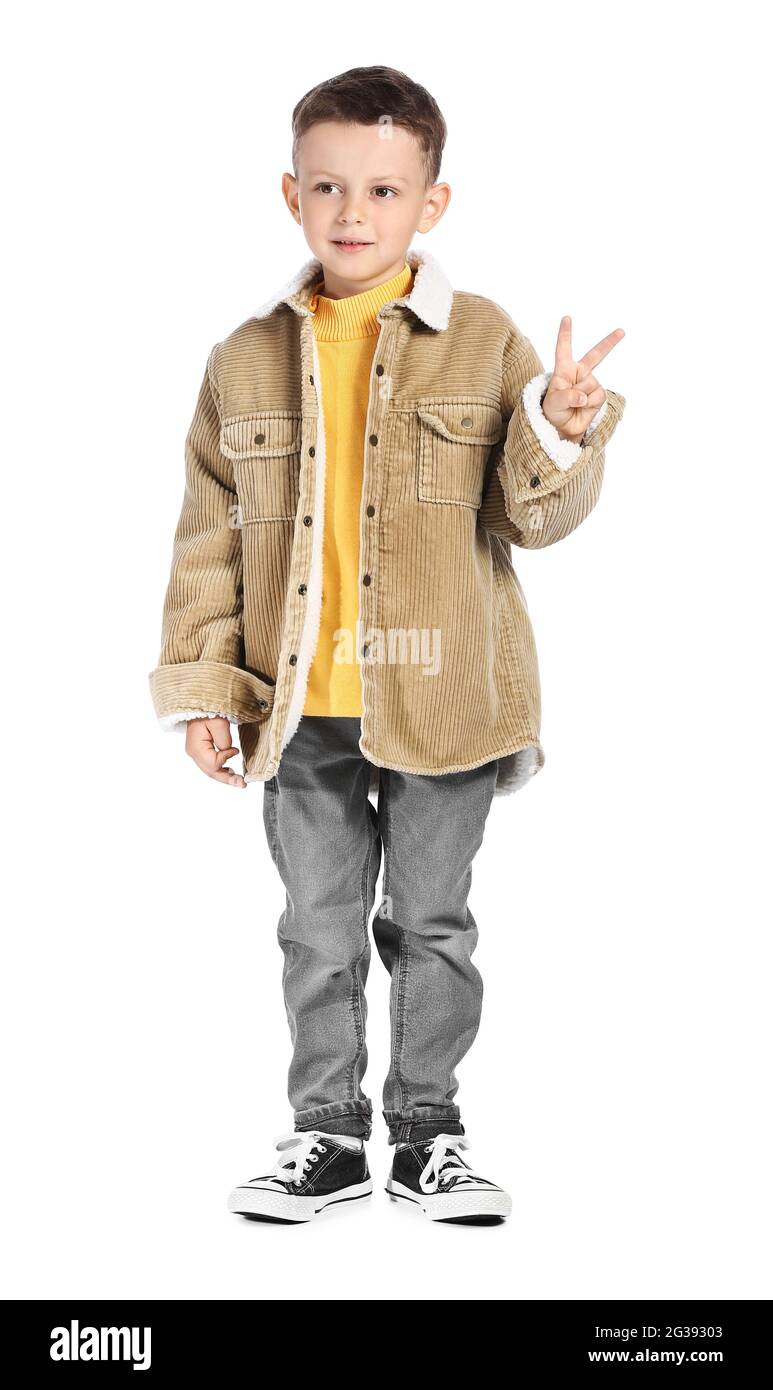 Portrait of cute little boy showing victory gesture on white background ...