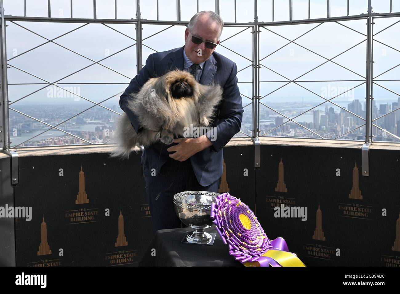 New York, USA. 14th June, 2021. David Fitzpatrick holds his dog, Wasabi ...