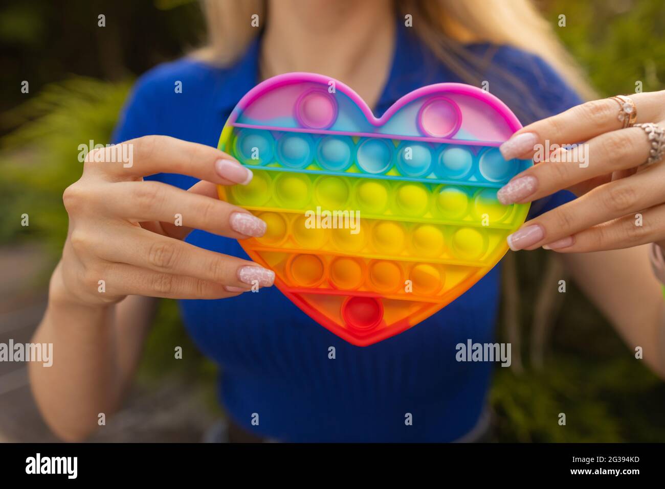 Woman using pop it fidget toy closeup Stock Photo - Alamy