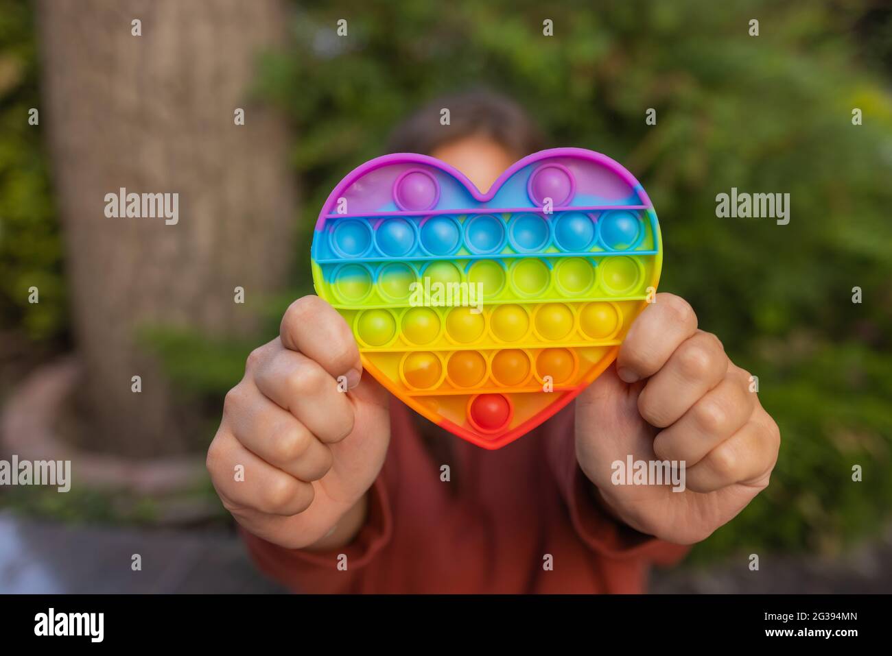 Woman using pop it fidget toy closeup Stock Photo - Alamy