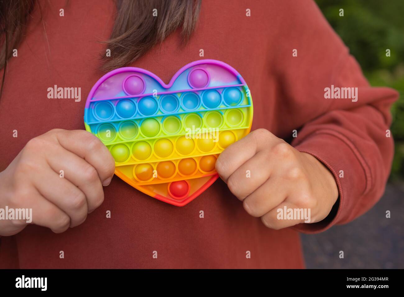 Woman using pop it fidget toy closeup Stock Photo - Alamy