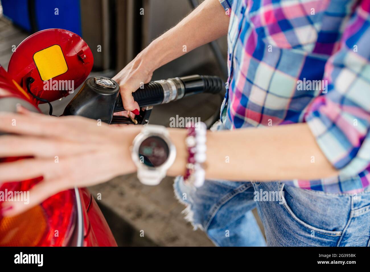 Woman pumping gasoline fuel in car at gas station Stock Photo - Alamy