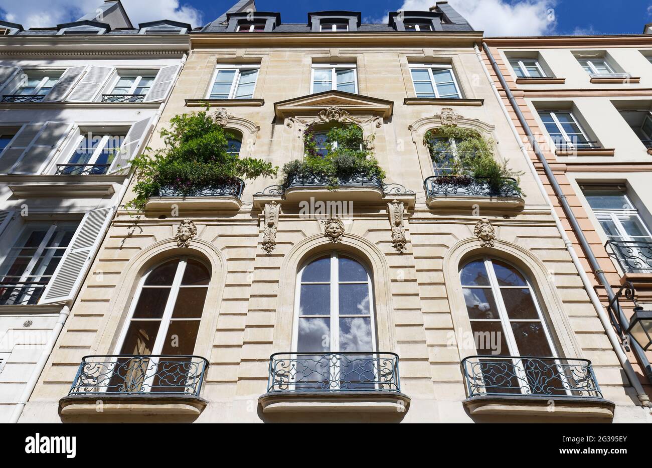 Traditional French house with typical balconies and windows. Paris ...