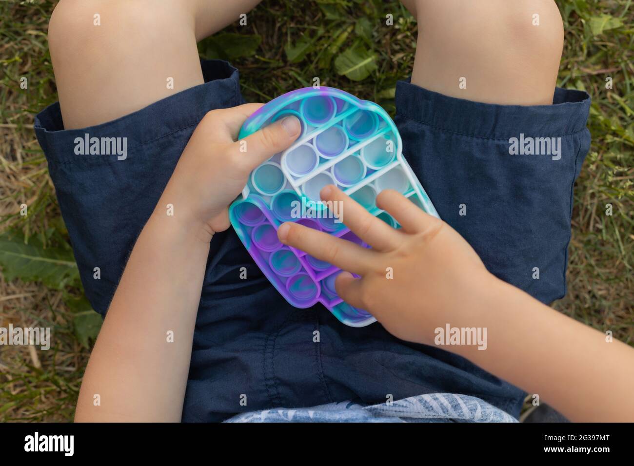 Colorful antistress sensory toy fidget push pop it in toddler's hands ...