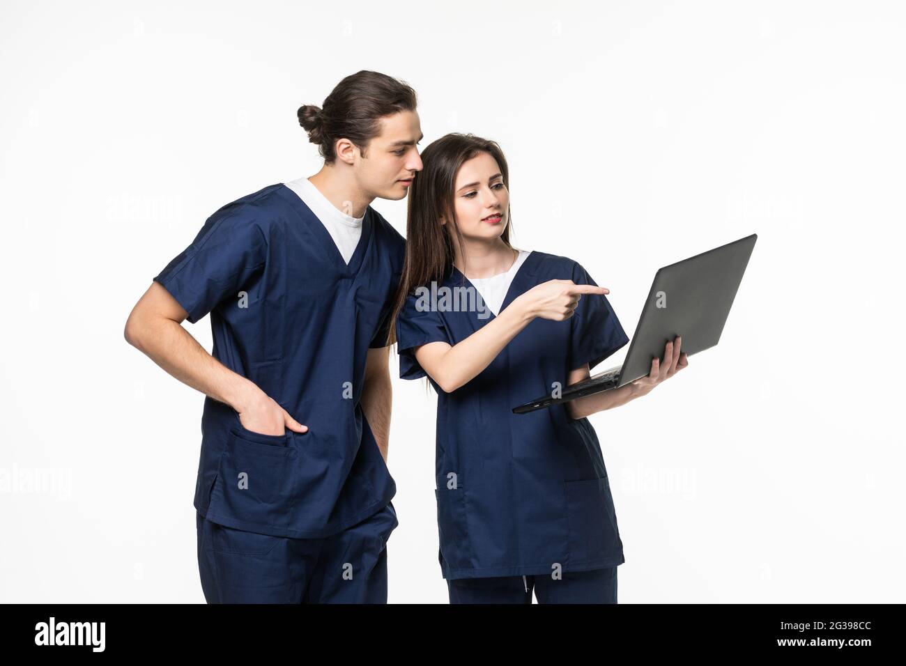 Two doctor and nurse research and hold laptop computer in hands finger ...