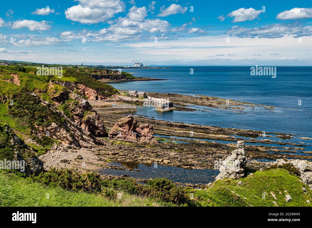 Clifftop view of Cove harbour and Torness nuclear power station in ...