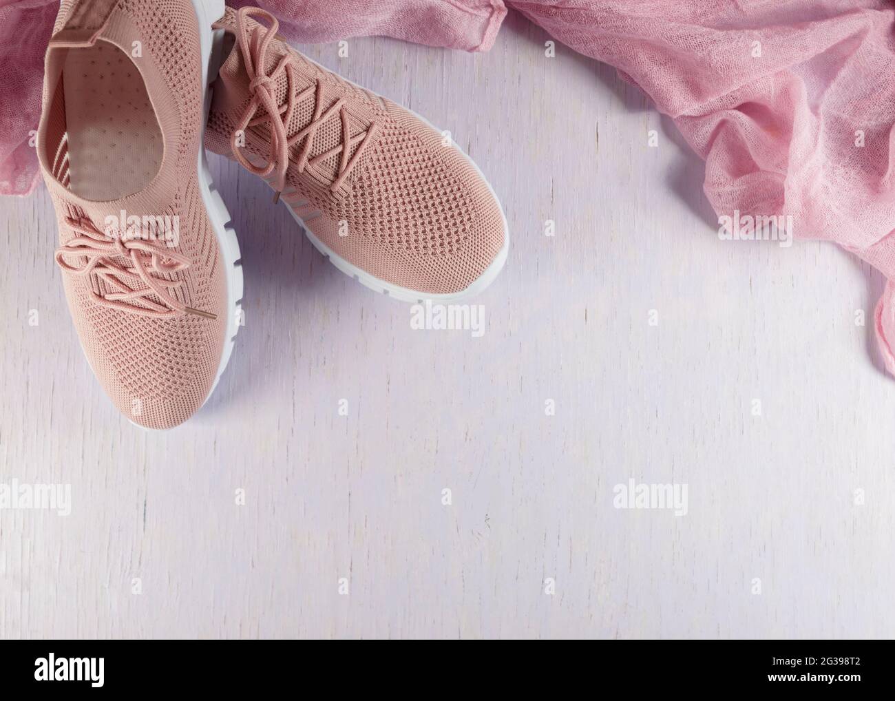 Pink women's lightweight, soft fabric shoes on a lilac background Stock ...