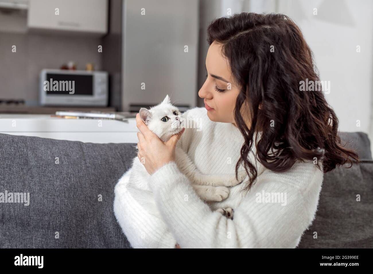 Young woman playing cat home hi-res stock photography and images - Alamy