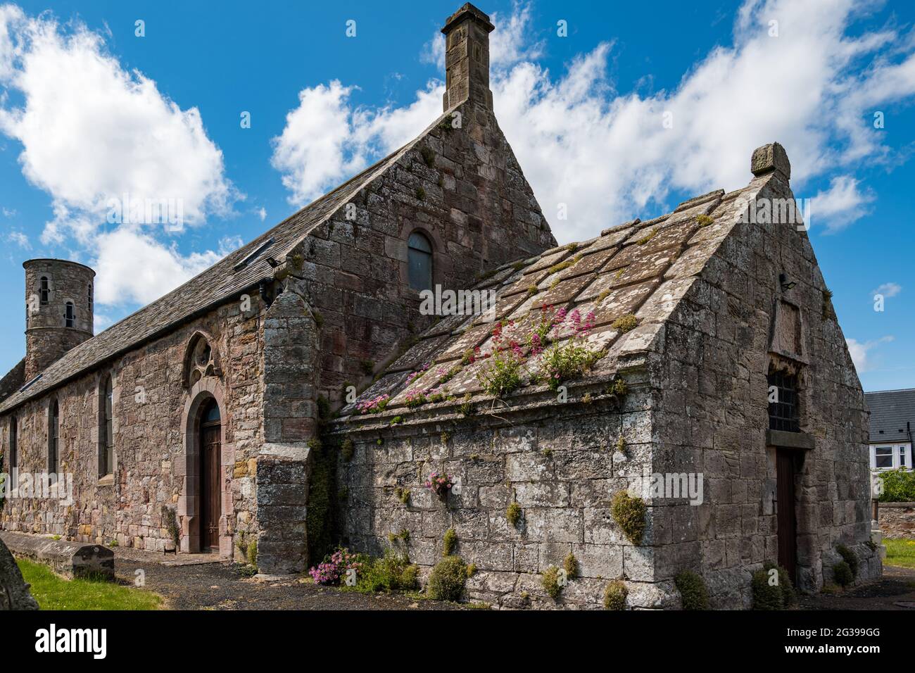 Small old traditional village church with unusual round tower ...